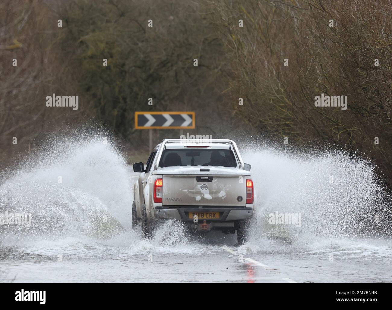 A vehicle makes a splash as The Welney wash fills with floodwater and ...