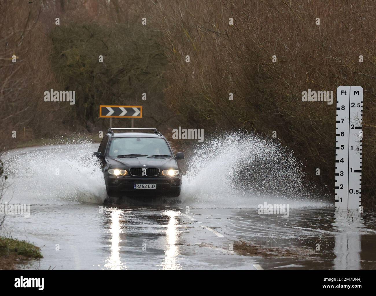 A vehicle makes a splash as The Welney wash fills with floodwater and ...