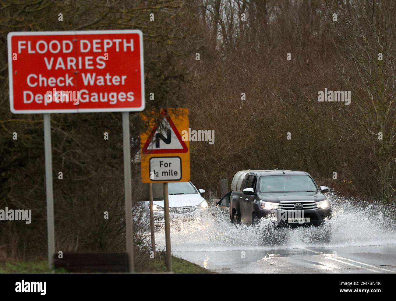 A vehicle makes a splash as The Welney wash fills with floodwater and ...