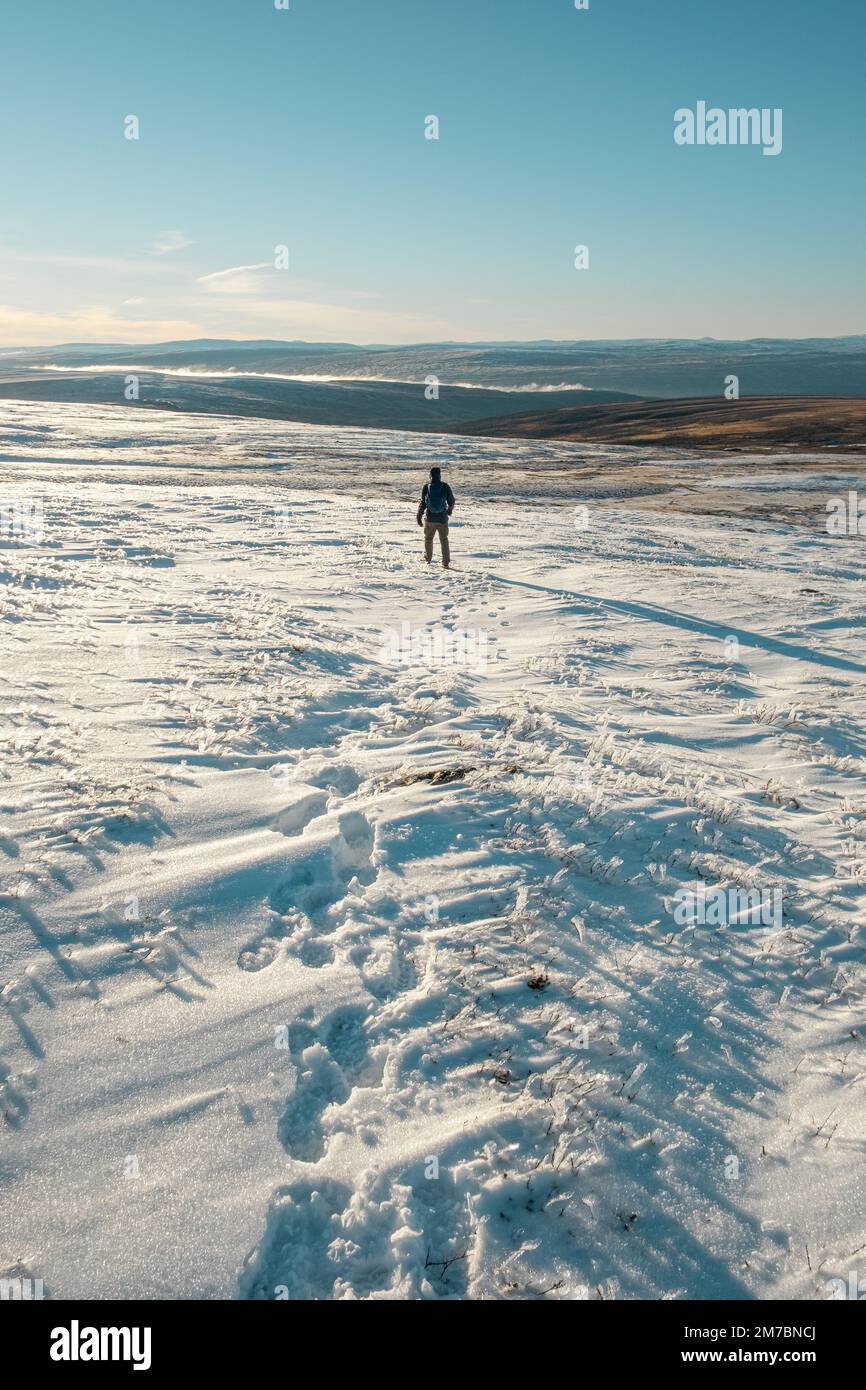 man hiking in beautiful winter landscape snow view from mountain ...