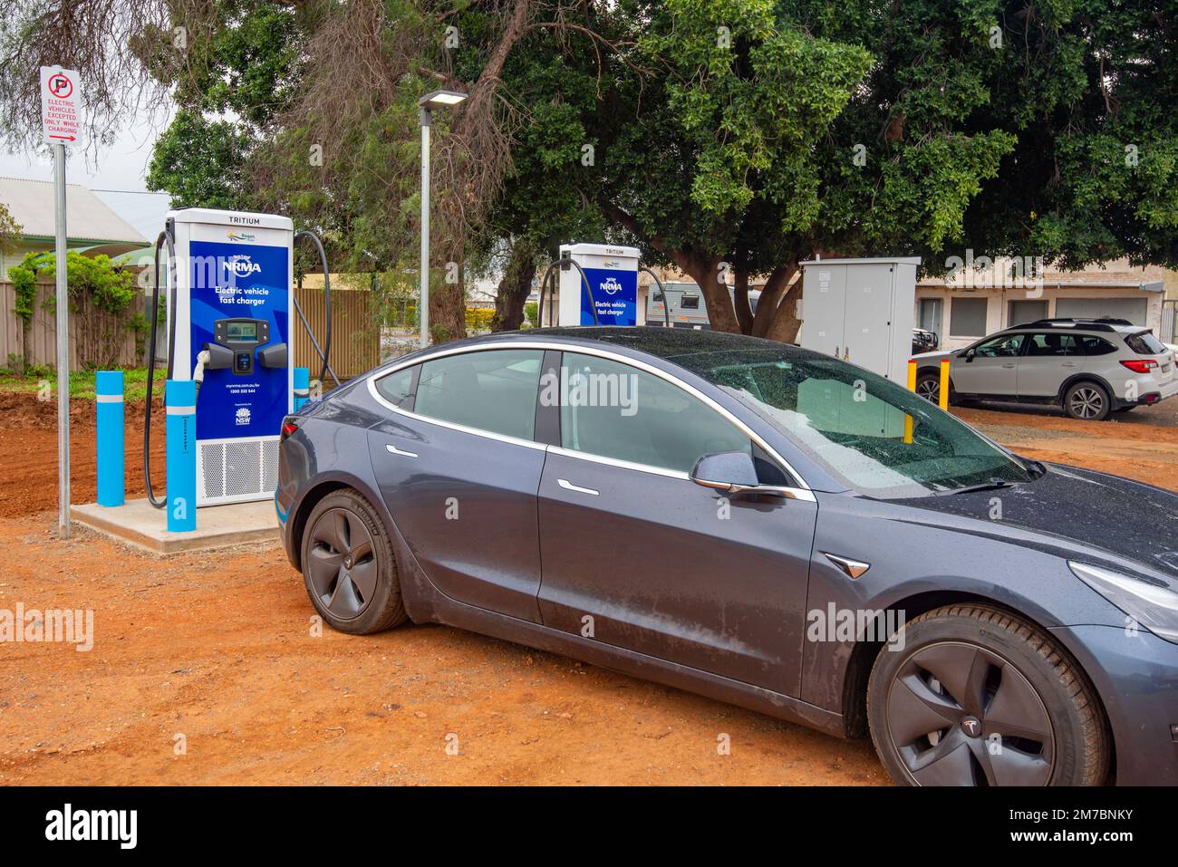 A car charging at a Tritium NRMA electric vehicle (EV) battery charging station in a carpark in ...