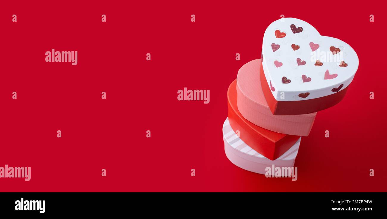 Set heart shaped boxes decorated with pink and red hearts on red ...