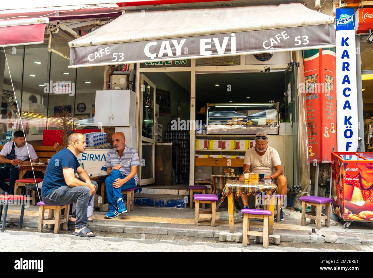 Traditional tea cafe with outdoor chairs and tables. Men drinking tea ...