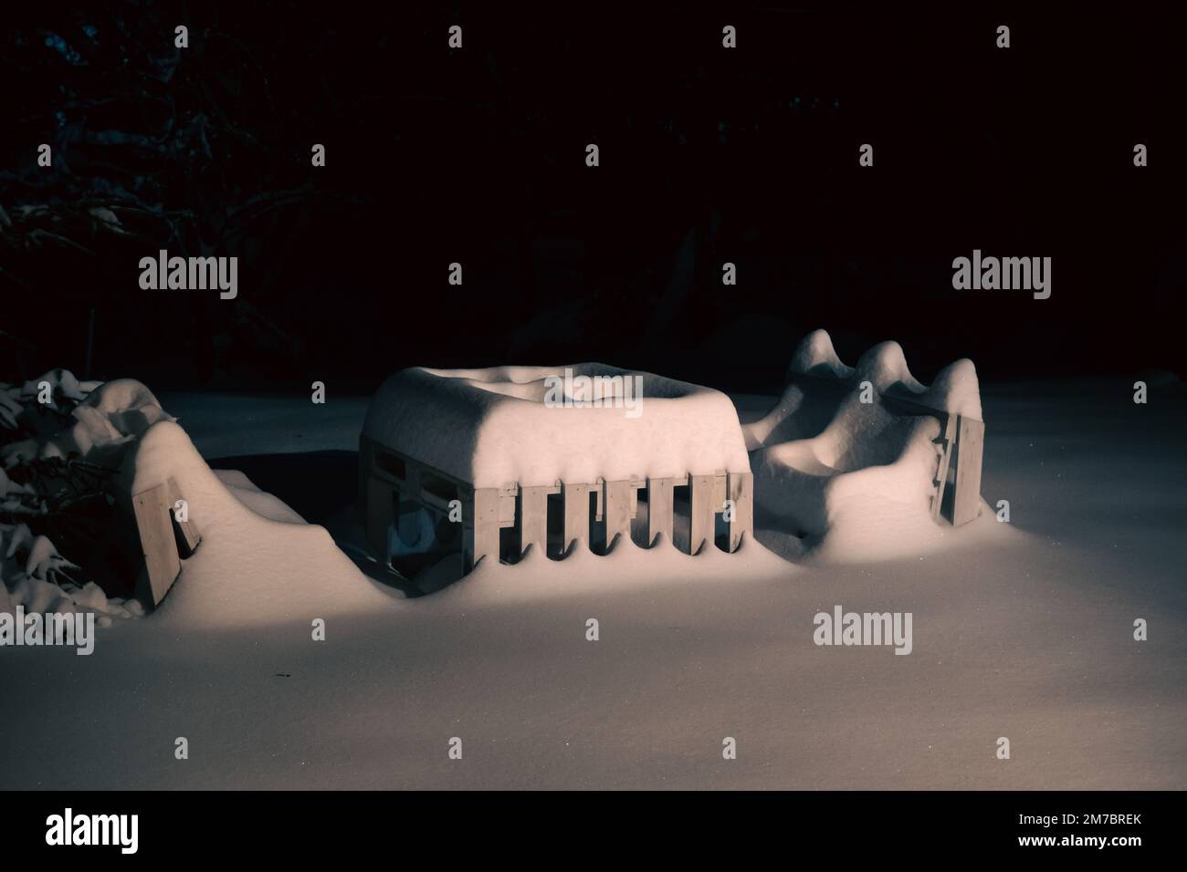Snowy bench made of pallets at dark night Stock Photo - Alamy