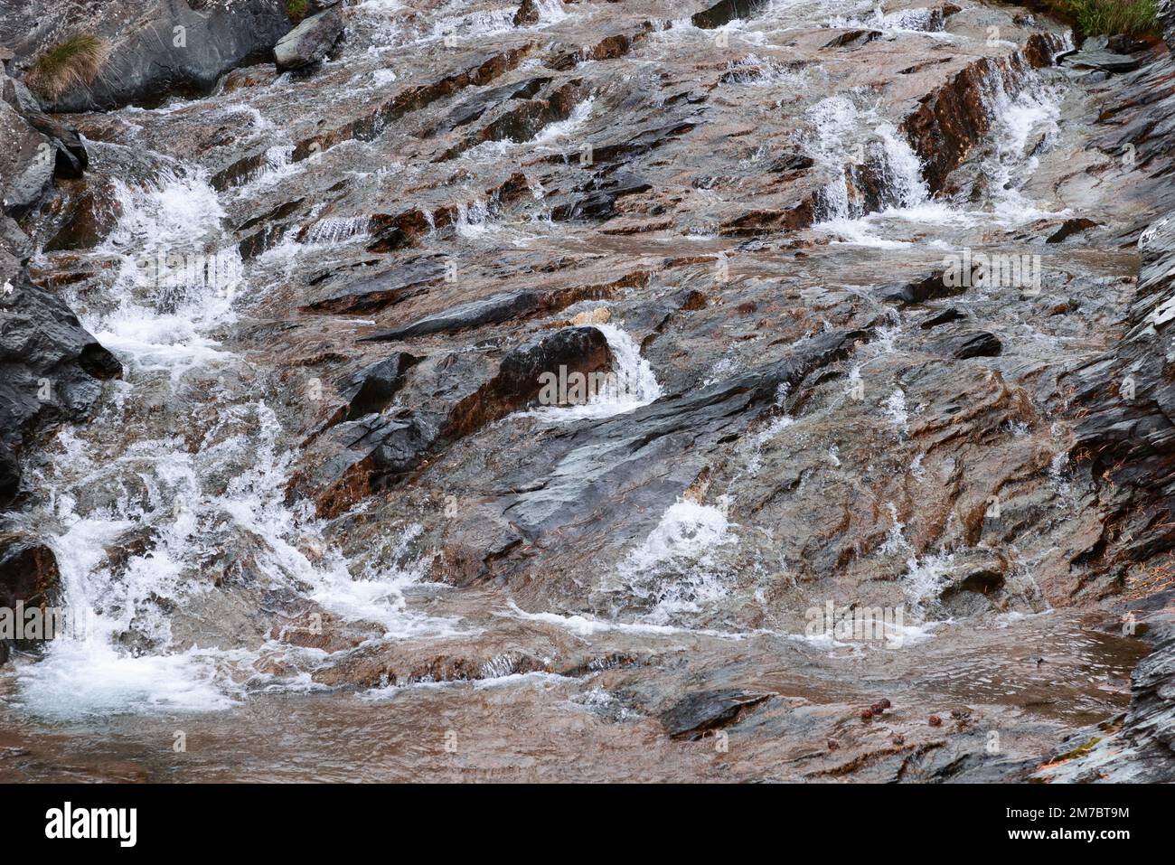 Beautiful texture of black-brown granite, saturated with various shades ...