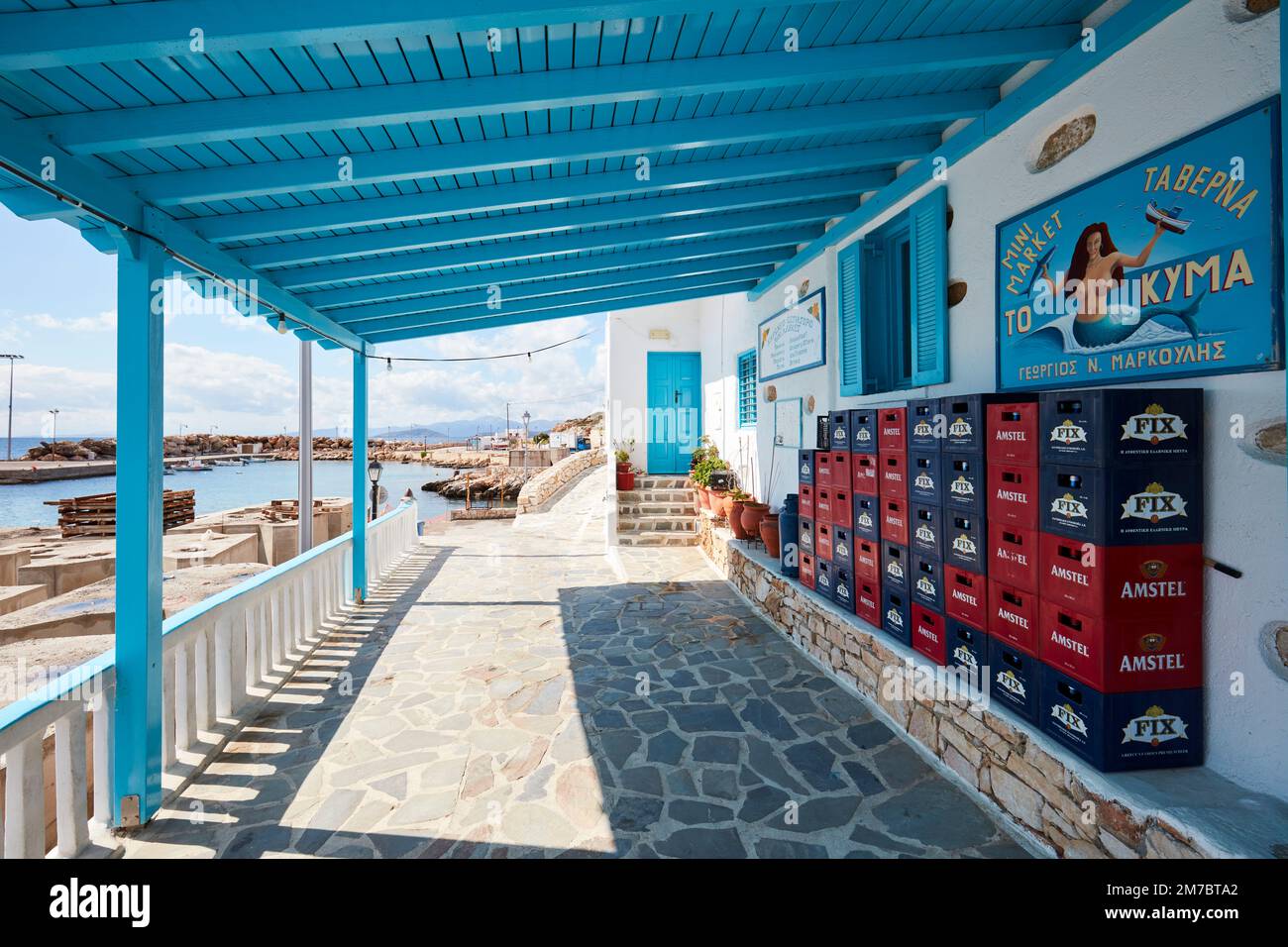 Cycladic restaurant terrace with traditional advertising and bins Stock ...