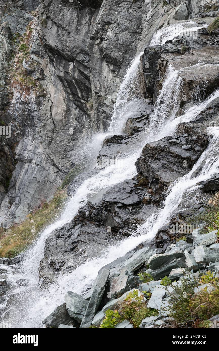 Foaming streams of alpine waterfall shot in contrast and with high ...