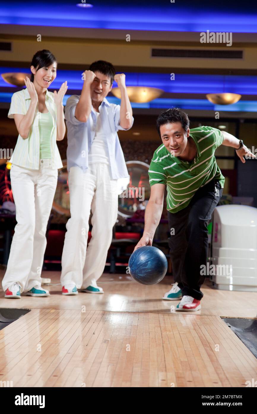 Three young women bowling hi-res stock photography and images - Alamy