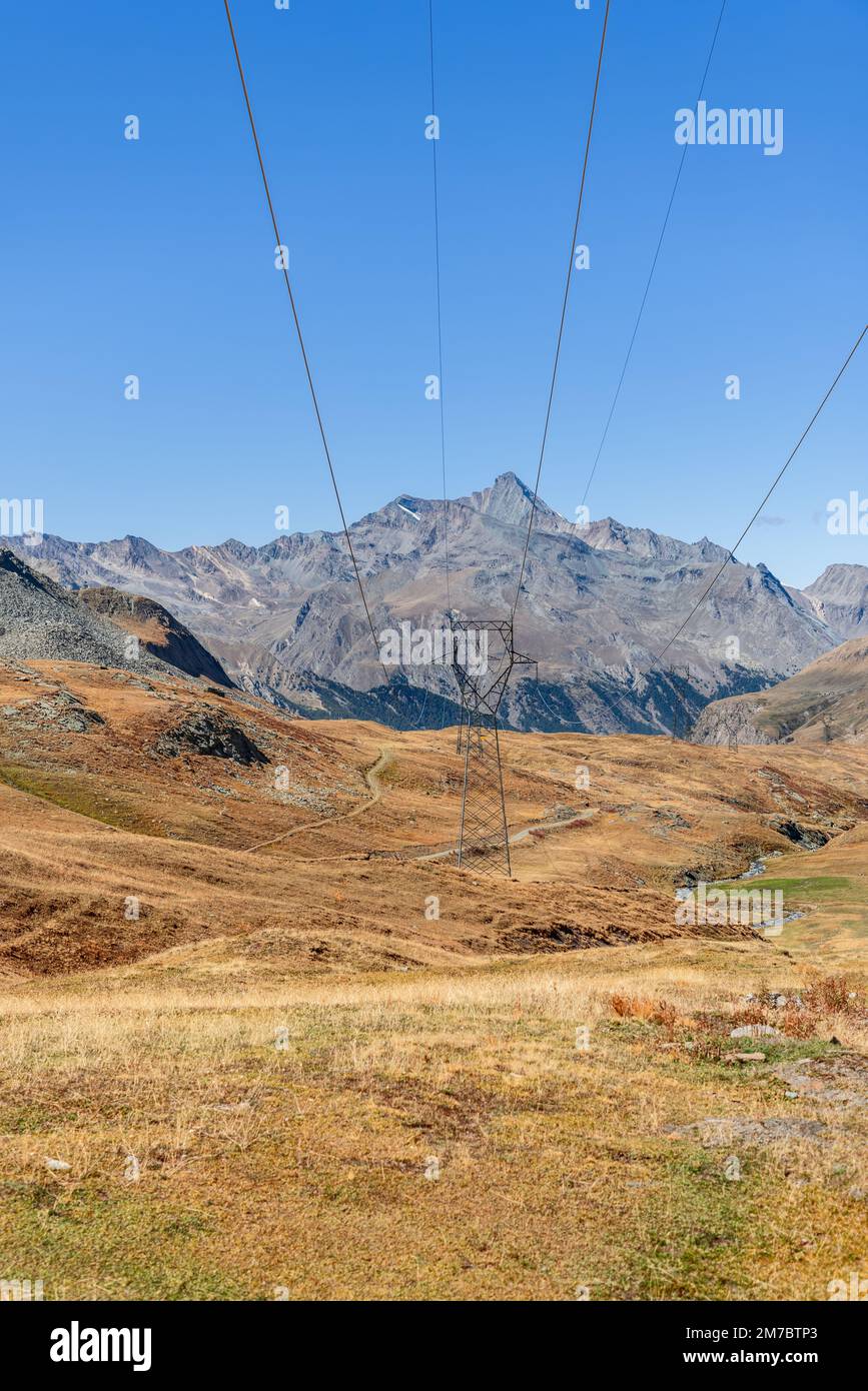 High-voltage power line descending from top into gorge and mast ...