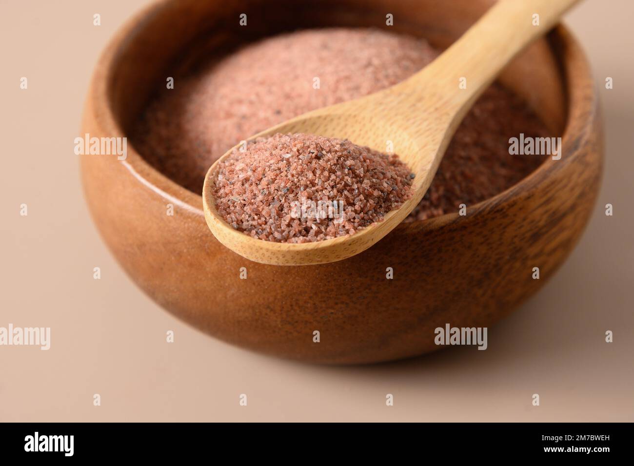 Indian Black salt, Kala namak in wooden bowl and spoon on beige ...