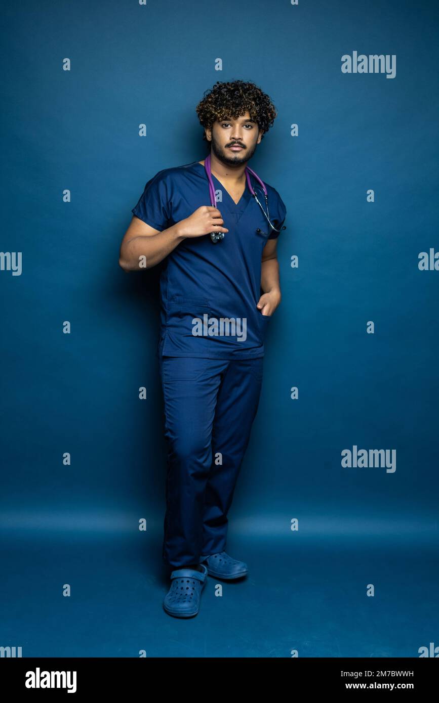 Full length portrait of doctor with stethoscope on light blue ...