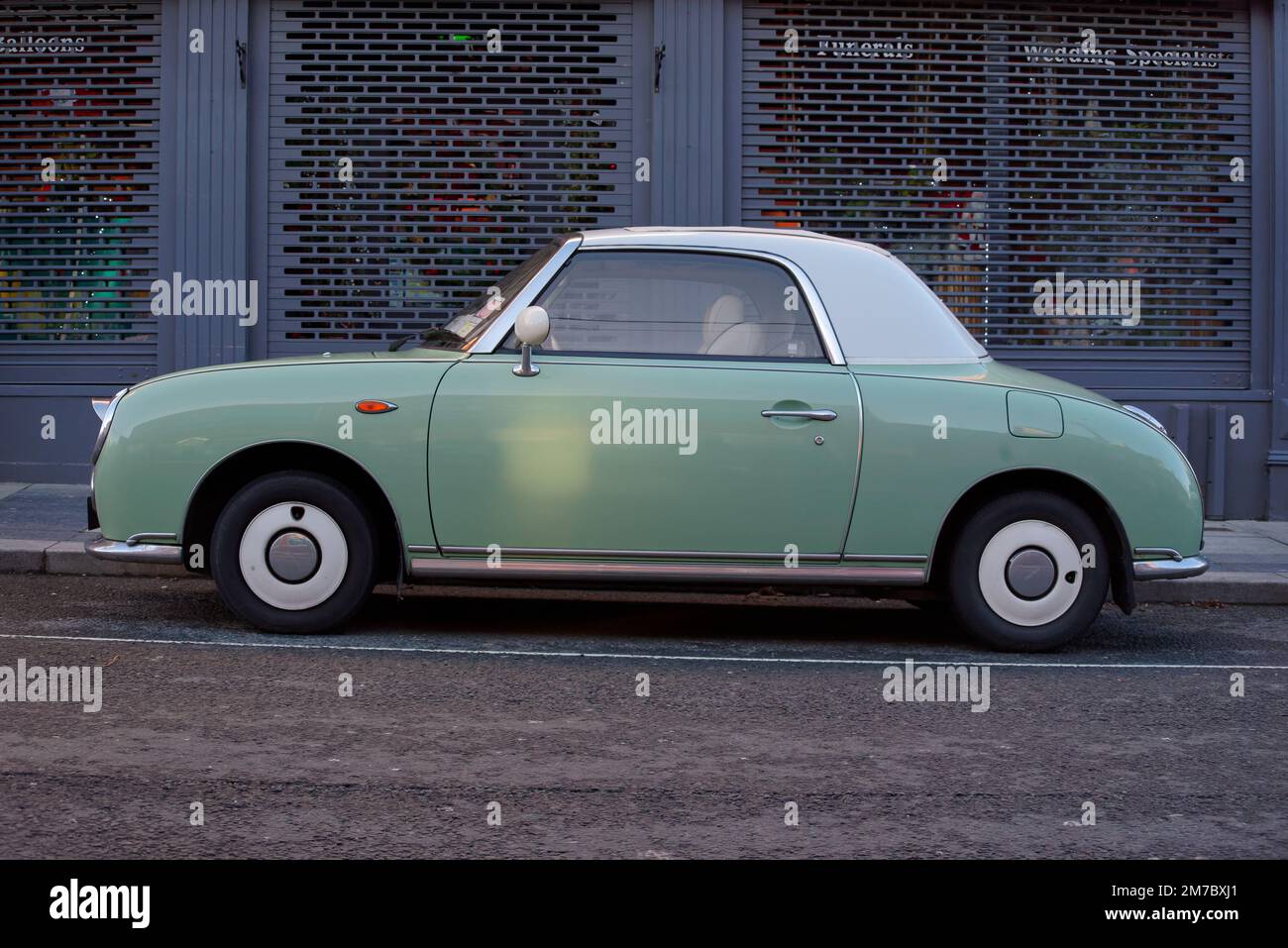 Side view of Nissan Figaro parked on a street in Bray, Ireland. Car ...