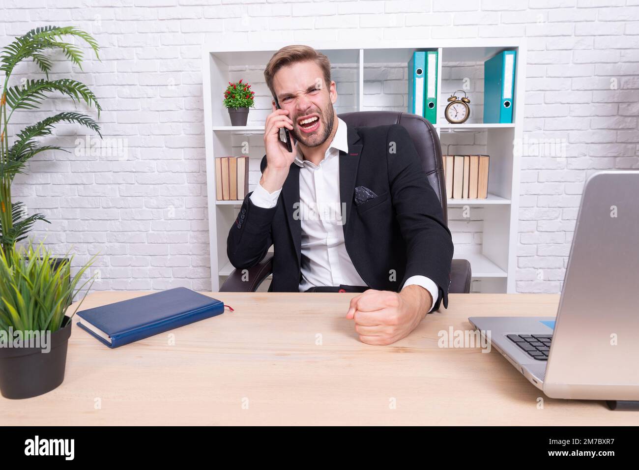 shouting businessman has phone talk on background. photo of businessman ...