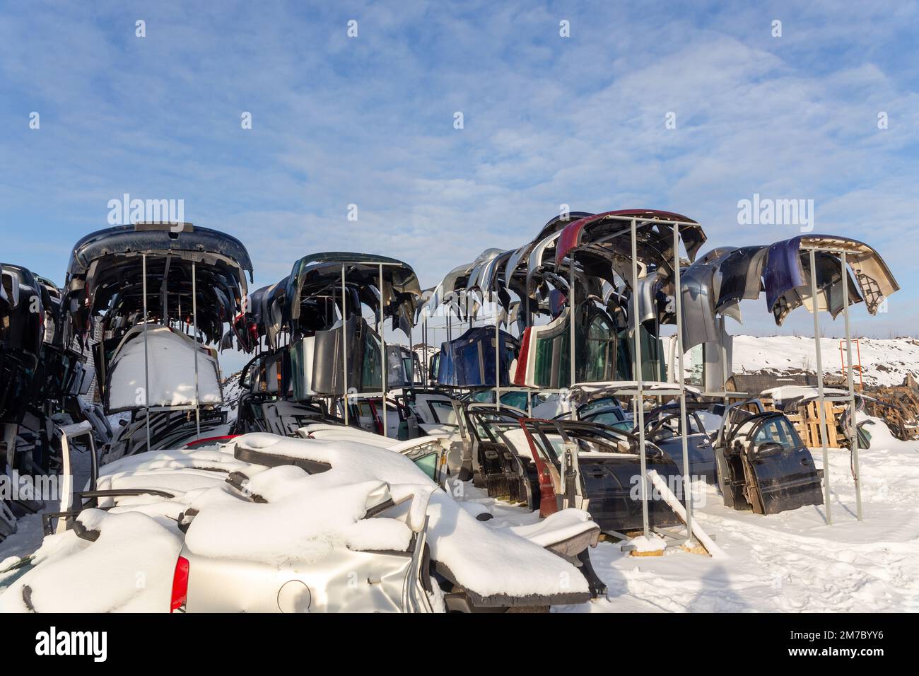 Disassembled cars on a car dump are on sale for spare parts. A stack of ...