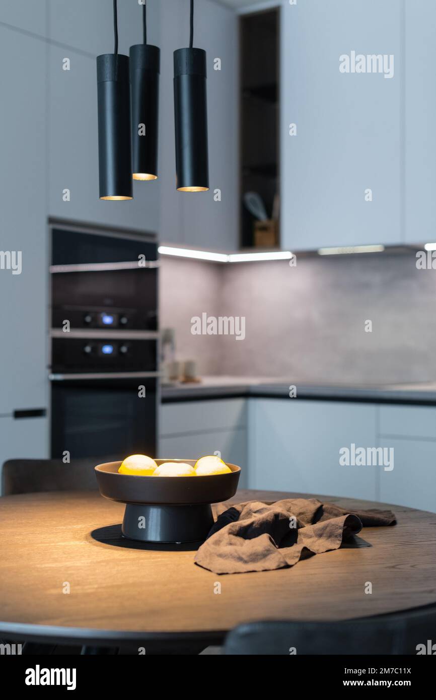 Kitchen with built in appliances and dining table of modern apartment ...