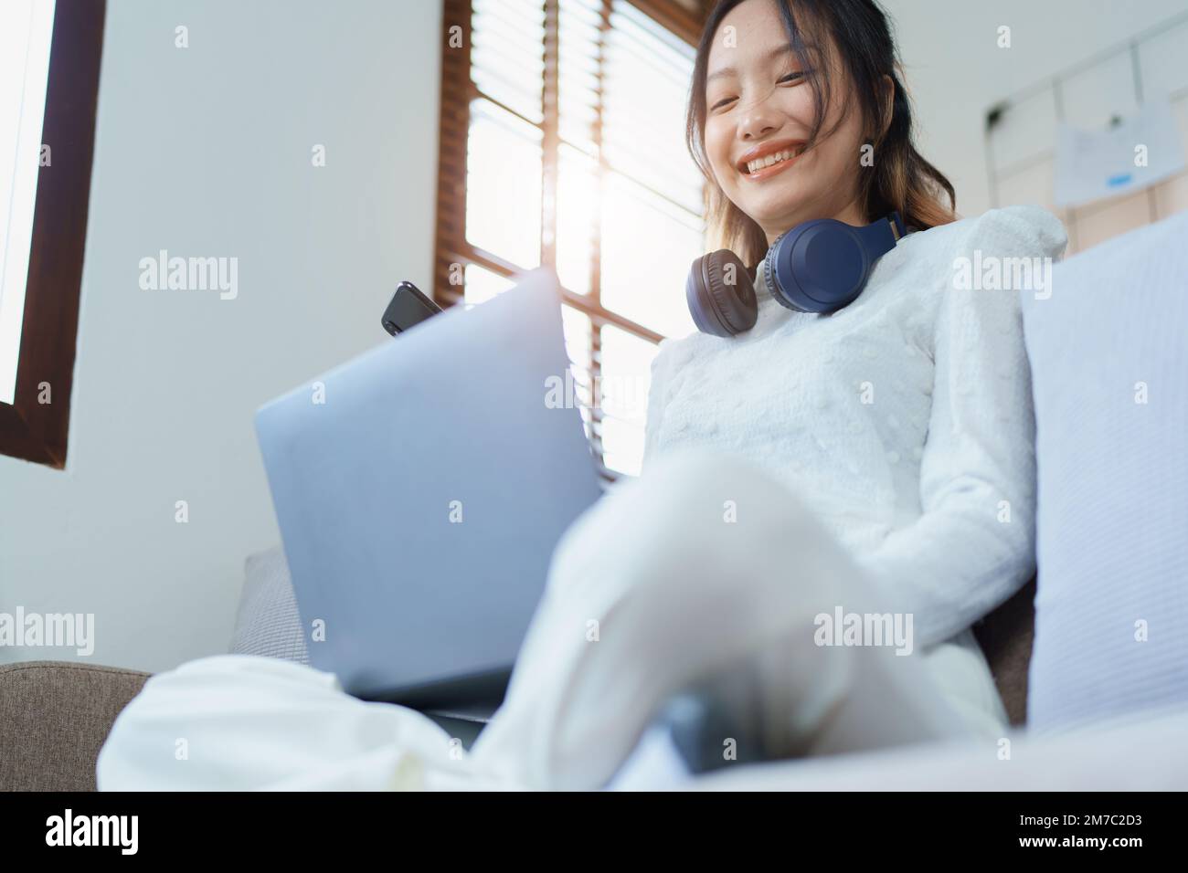 Portrait of a beautiful Asian teenage girl using a computer Stock Photo ...
