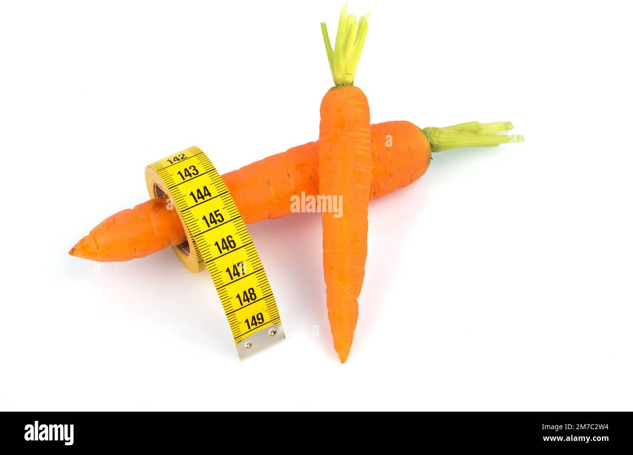 fresh carrots with measuring tape, diet Stock Photo - Alamy
