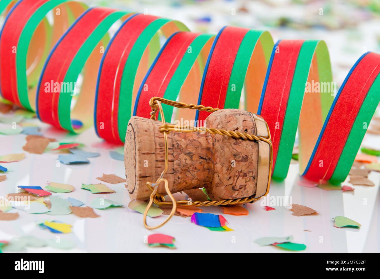 Champagne cork with muselet, paper streamer and confetti at sylvester ...