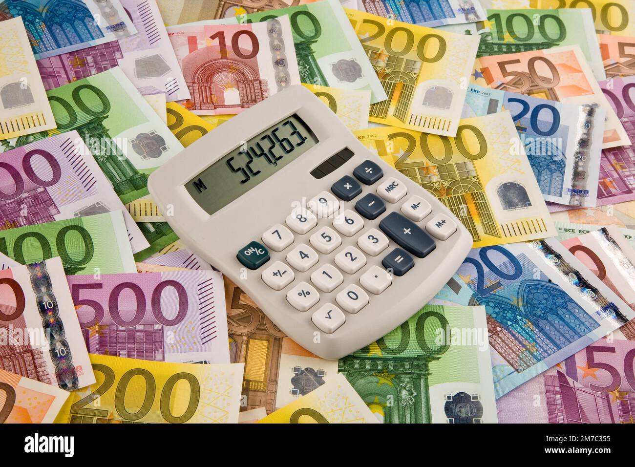 calculator with many different euro bills Stock Photo - Alamy