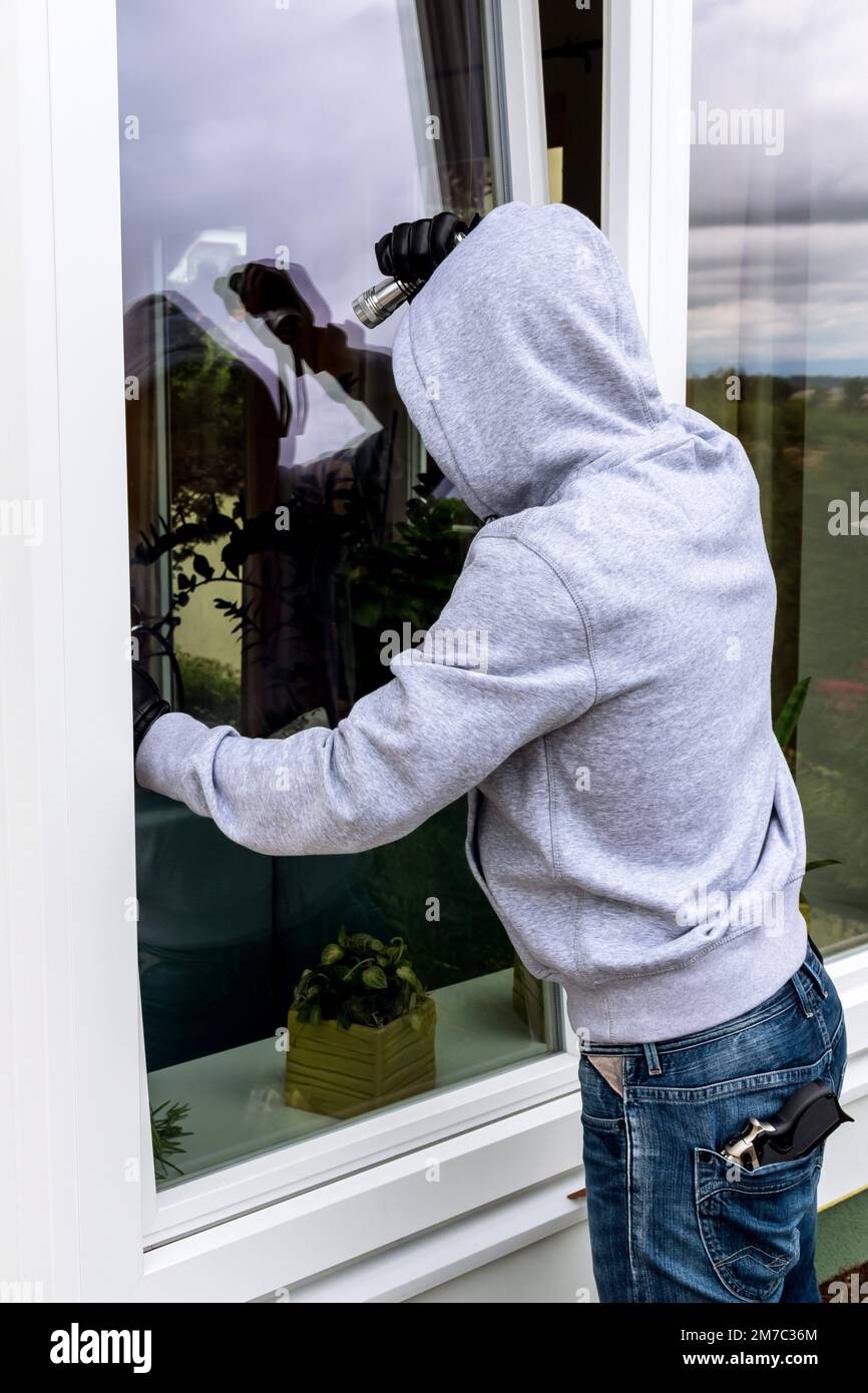thief with pistol and torch light at an open window Stock Photo - Alamy