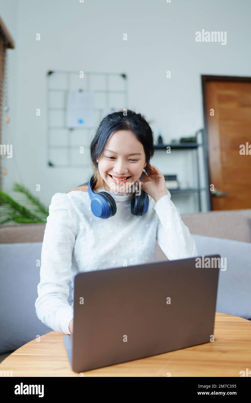 Portrait of a beautiful Asian teenage girl using a computer Stock Photo ...