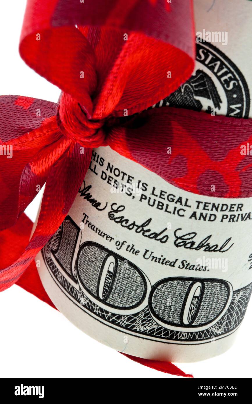 100 Dollar bill with a red bow as a Christmas gift, gift of money Stock ...