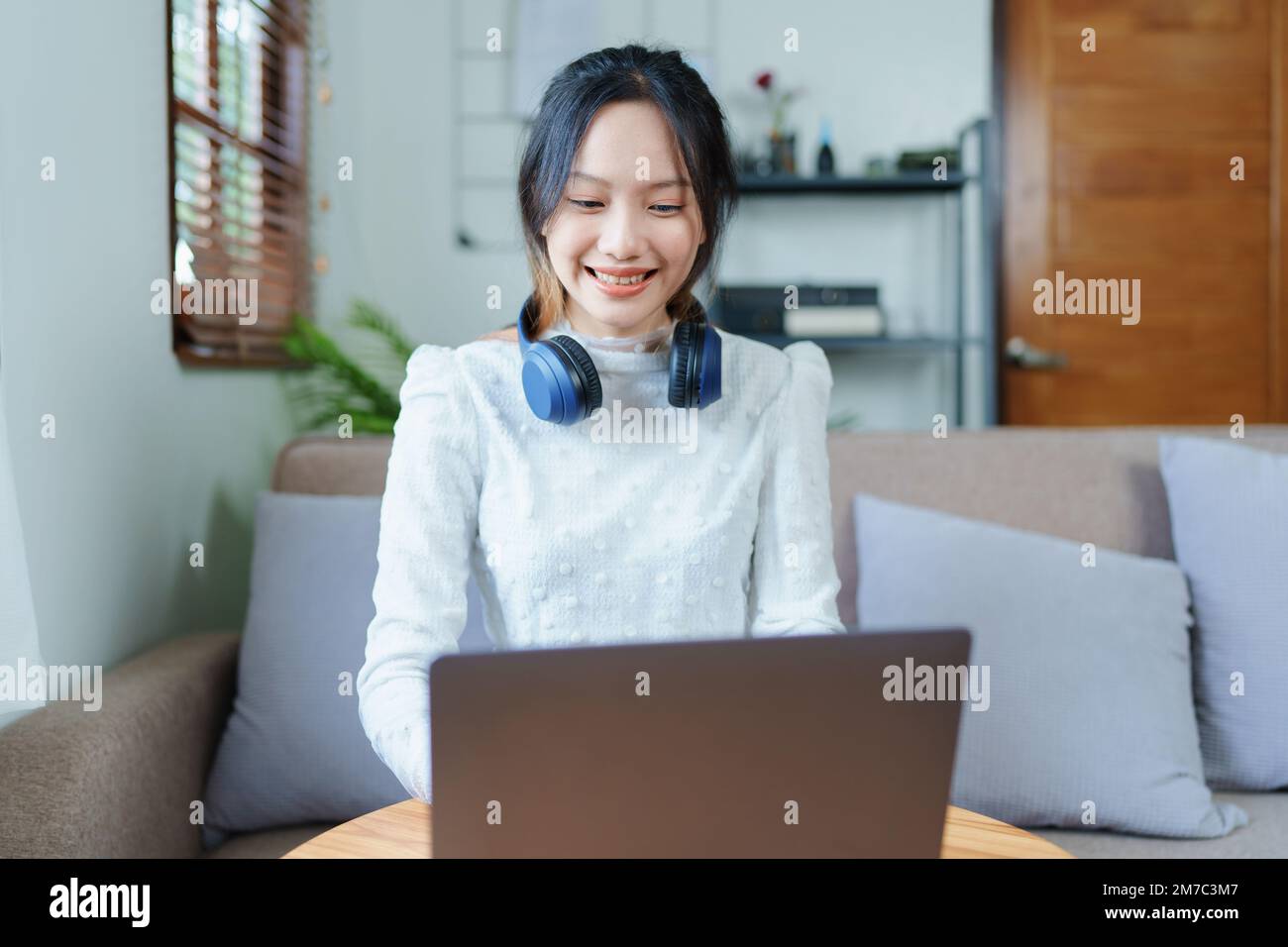 Portrait of a beautiful Asian teenage girl using a computer Stock Photo ...