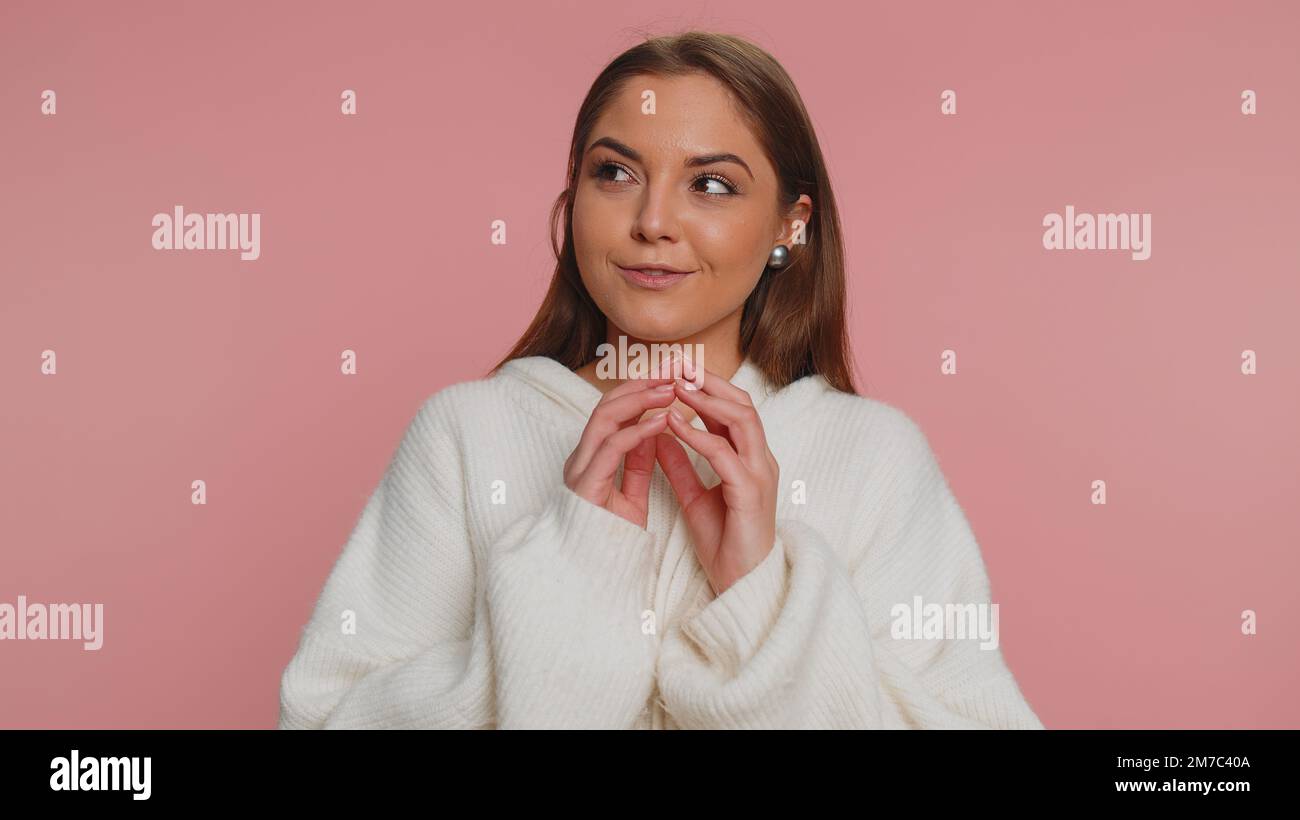 Sneaky cunning young woman with tricky face gesticulating and scheming ...