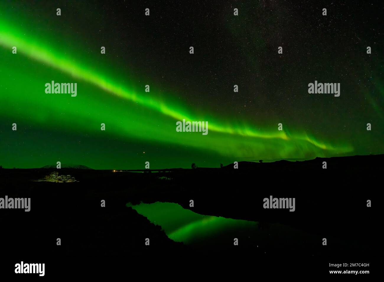 Aurora Borealis green beams with lake reflection Stock Photo - Alamy