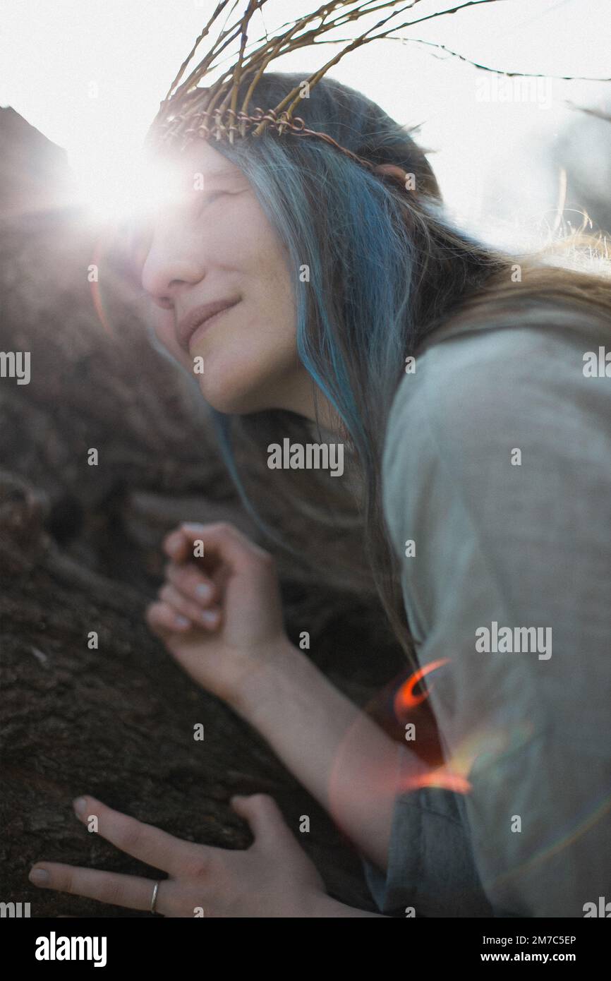 Close up celtic styled delighted woman face in bright sunlight portrait ...