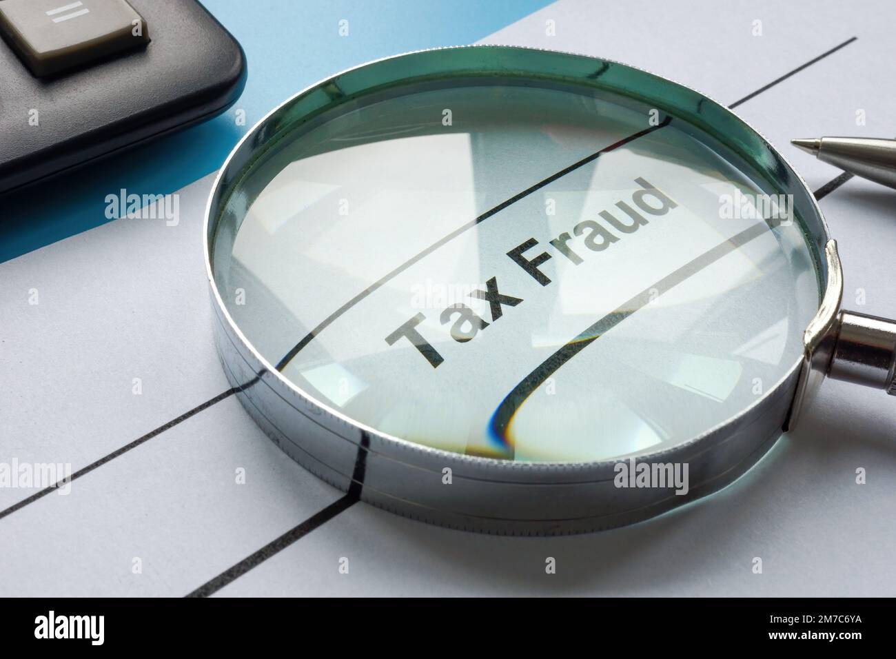 Documents about tax fraud and magnifying glass Stock Photo - Alamy