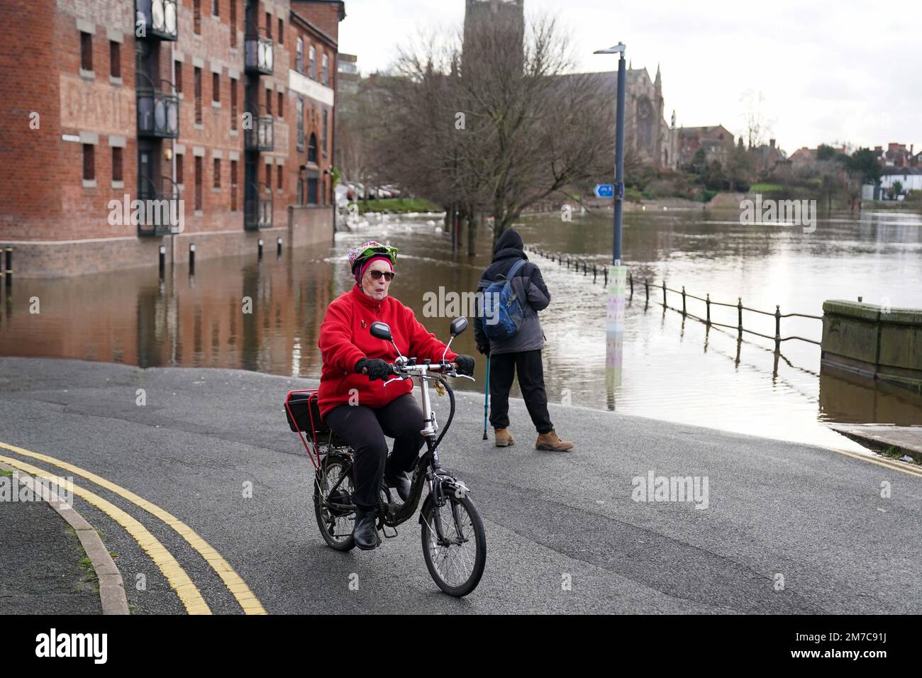 People Pass The Overflowing River Severn In Worcester Following