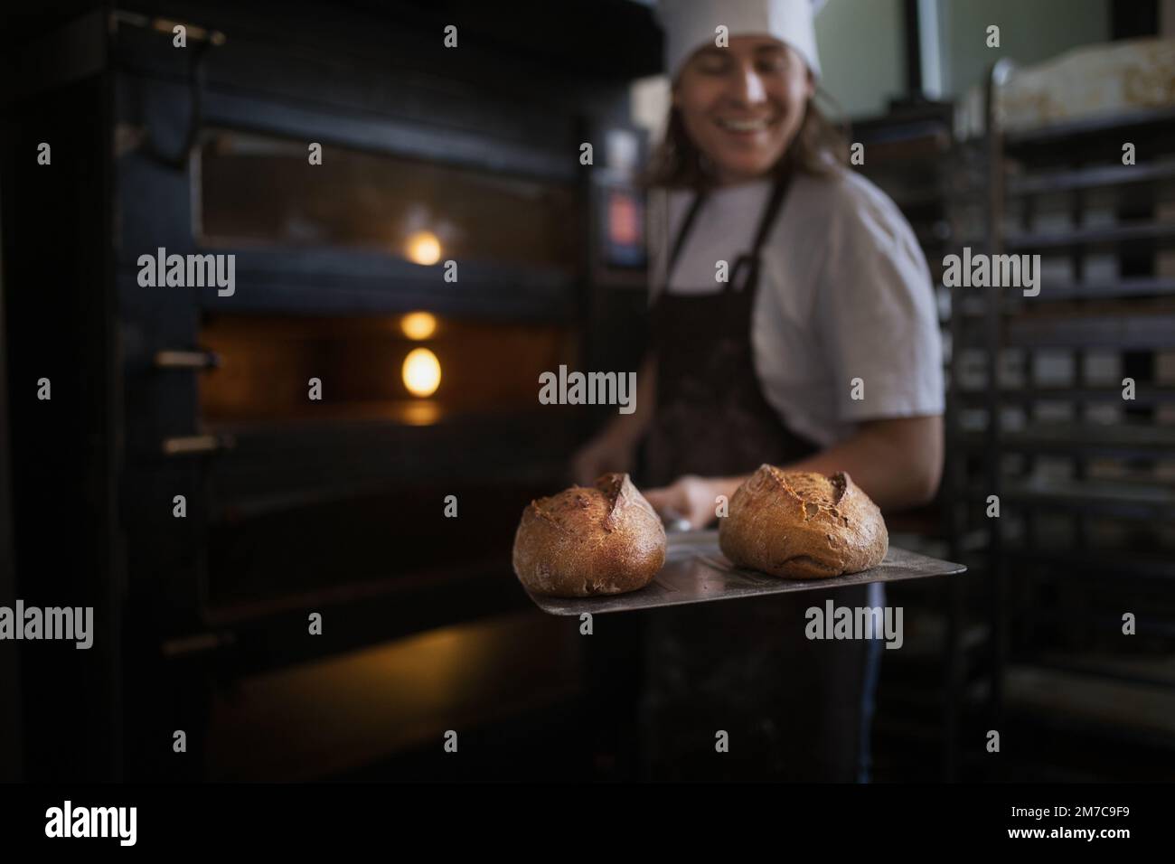 Happy young pastry baker hi-res stock photography and images - Alamy