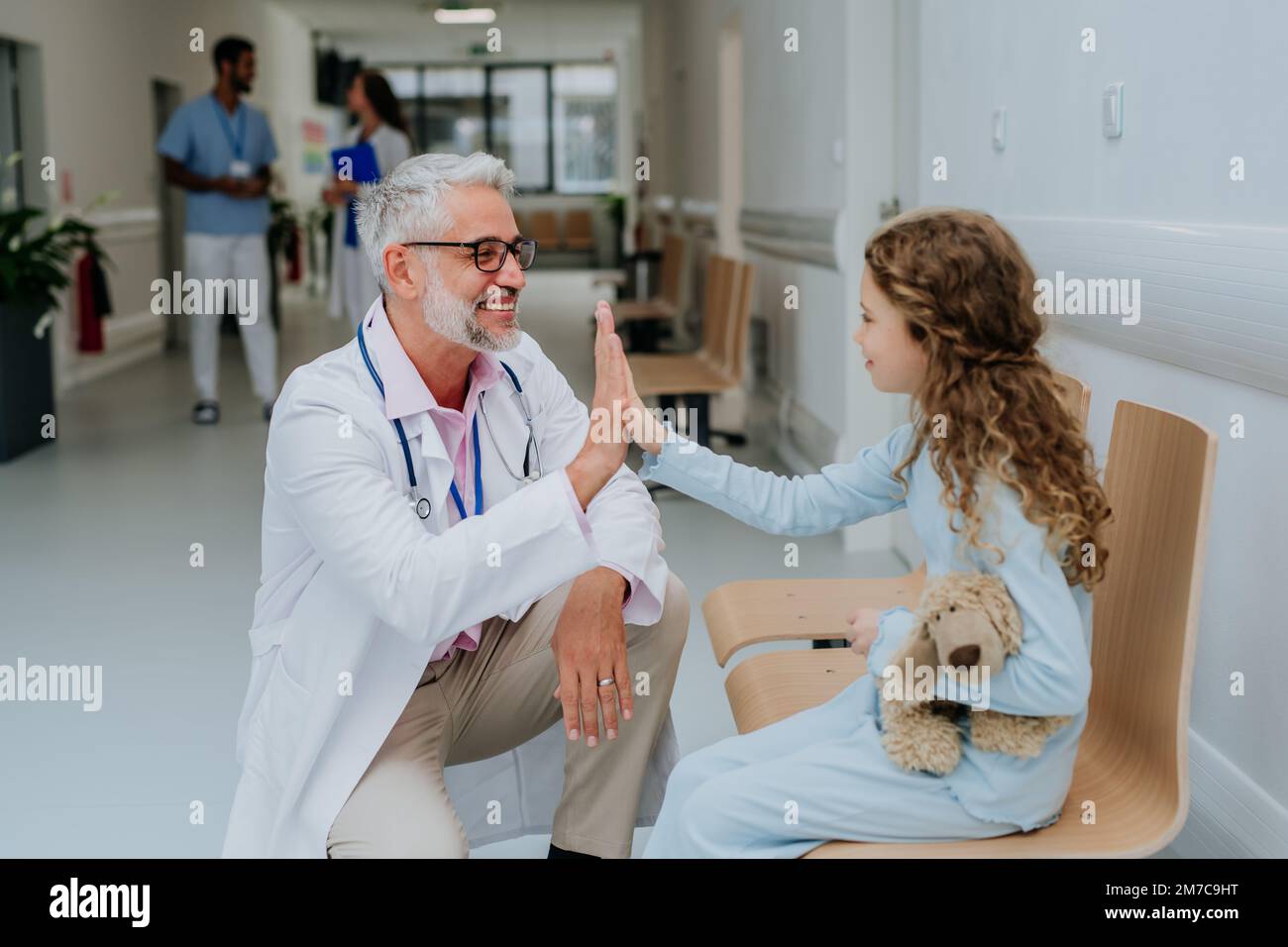 Doctor playing with his little patient at pediatrics Stock Photo - Alamy