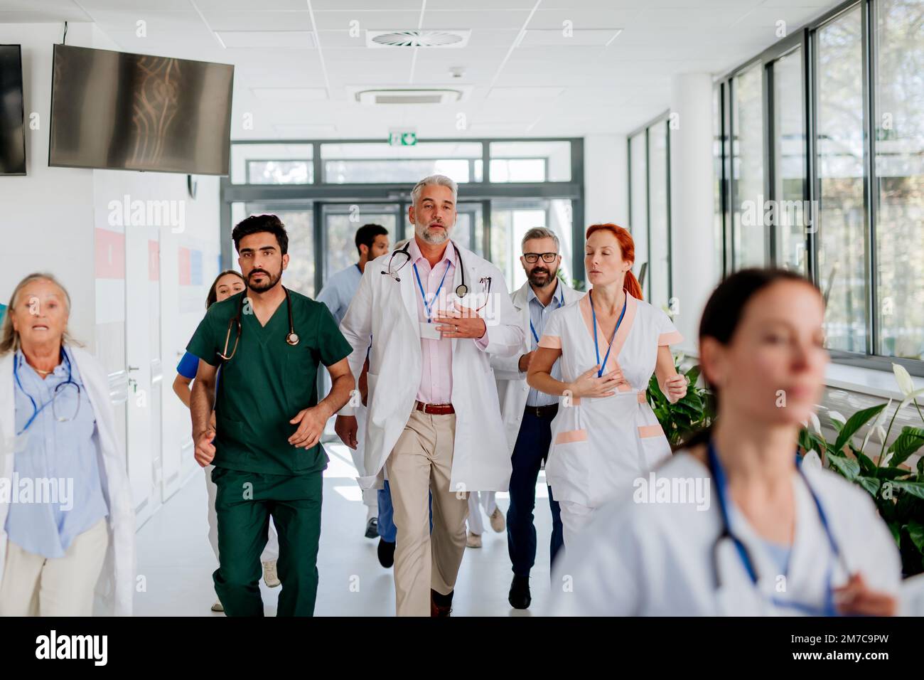 Young stressed doctors running at hospital corridor Stock Photo - Alamy
