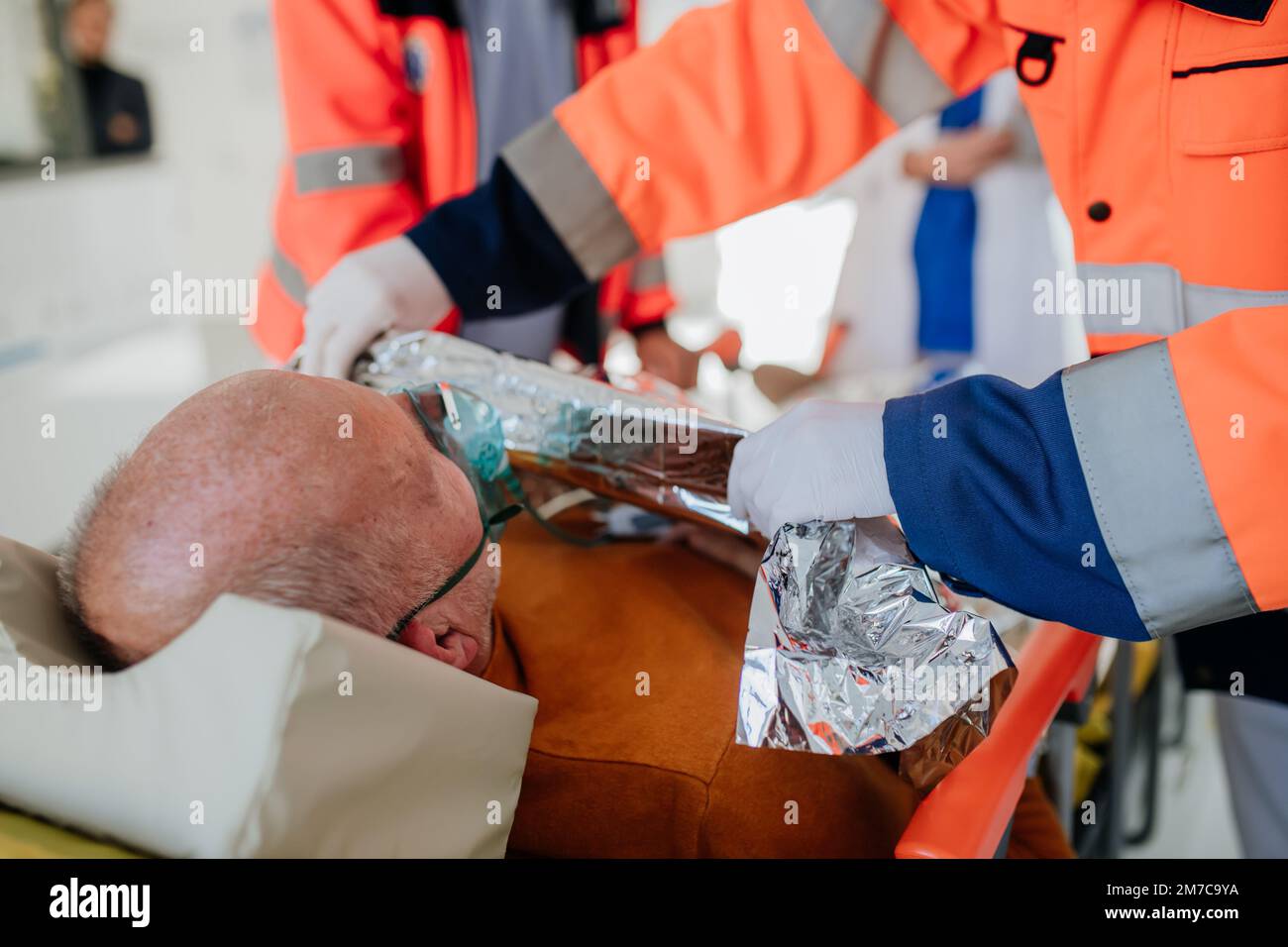 Rescuers taking care of patient from ambulance, close-up Stock Photo ...