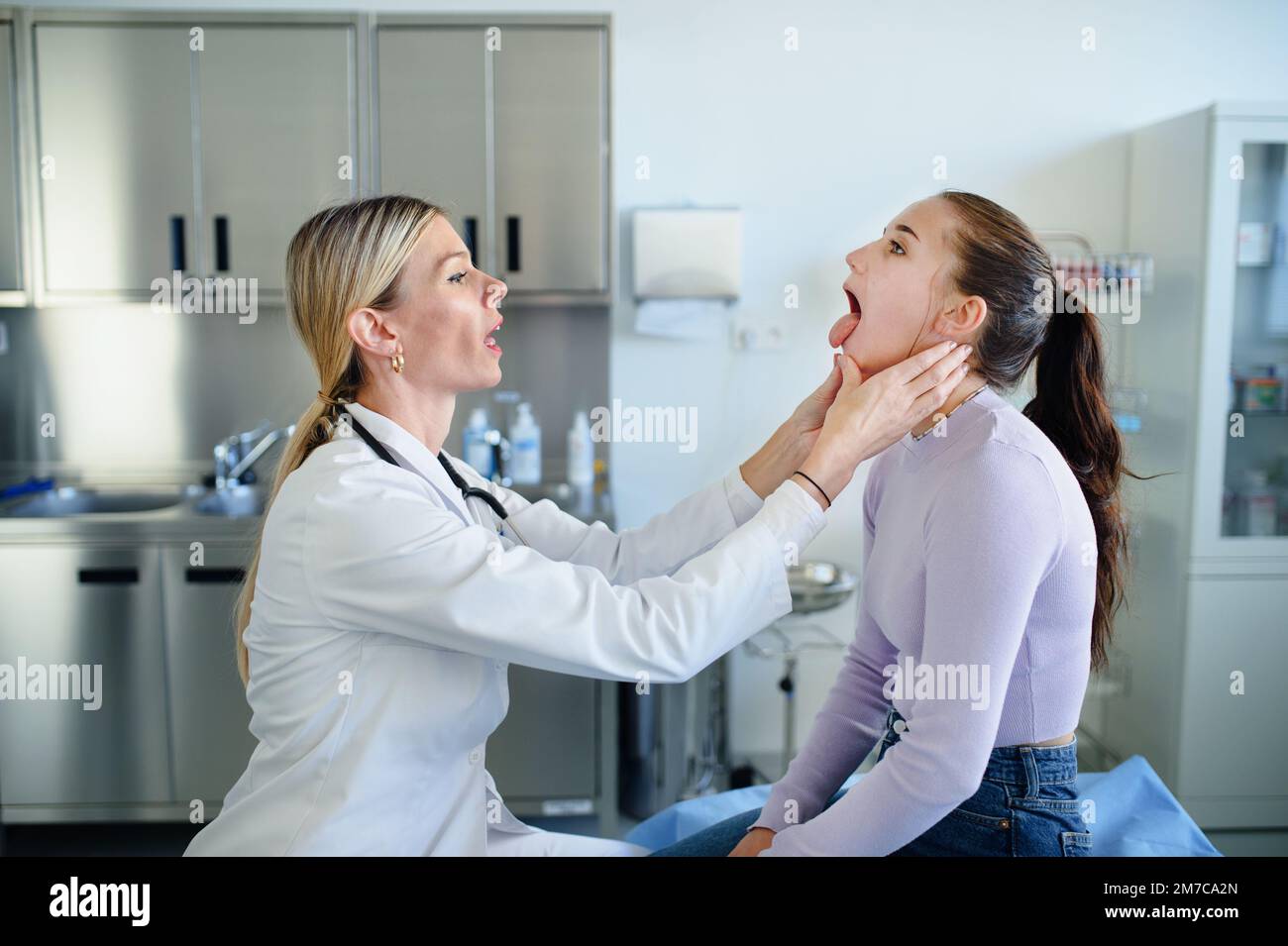 Young woman doctor examining teenage girl in her ambulance Stock Photo ...