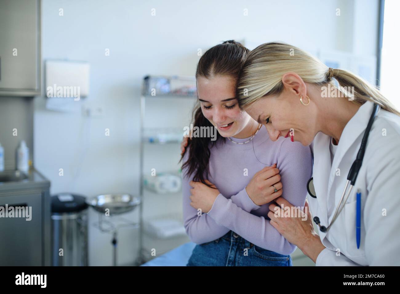 Young woman doctor laughing with teenage girl in her ambulance Stock ...