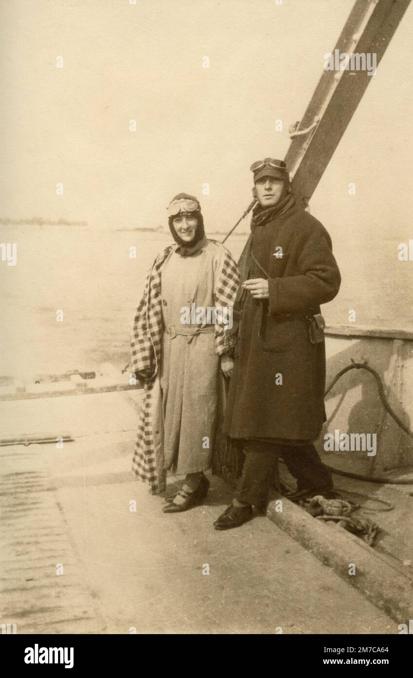 Couple dressed for car traveling onboard a ferry, Italy 1920s Stock ...