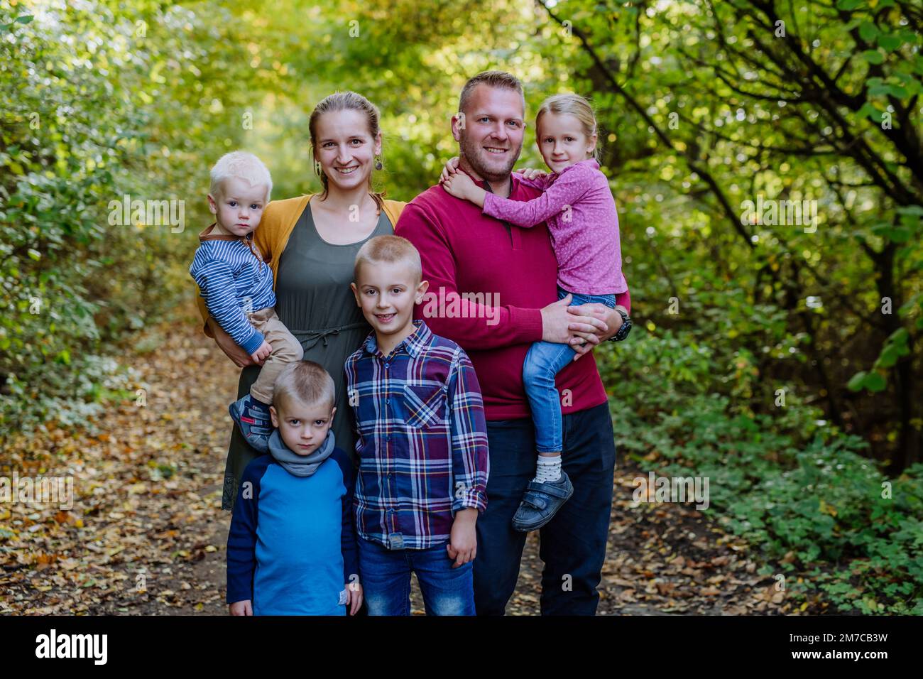 Portrait of happy family with kids in a forest Stock Photo - Alamy