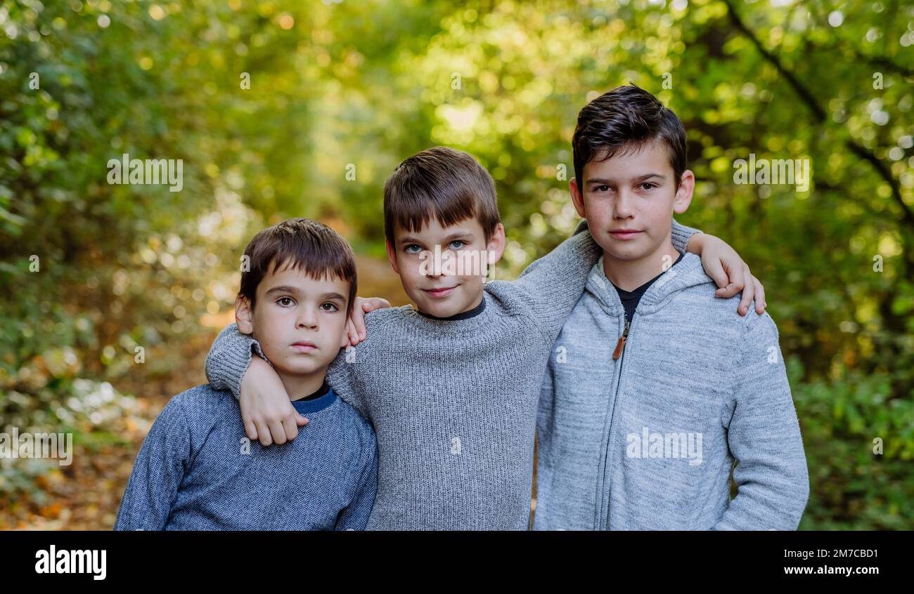 Portrait of three boys, brothers standing in forest Stock Photo - Alamy