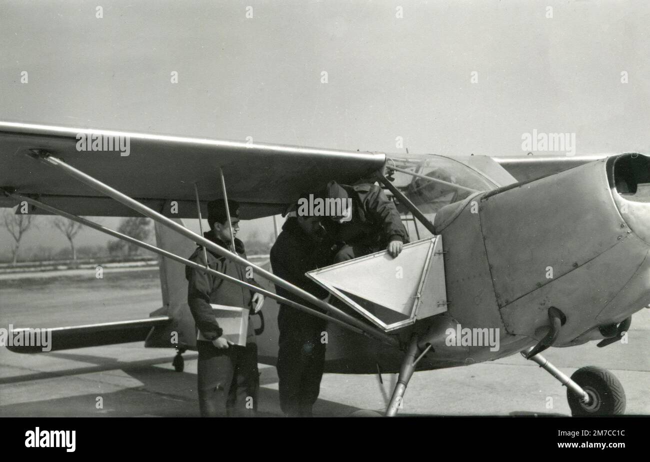 Pilots boarding a small training aircraft during Marte II aviation ...