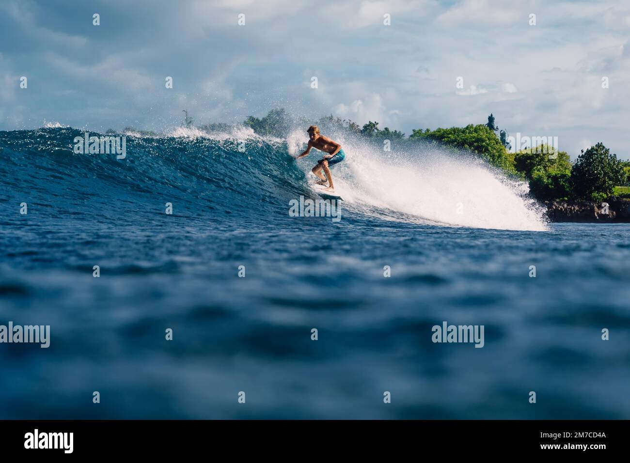 January 4, 2023. Bali, Indonesia. Man in tropical ocean during surfing ...