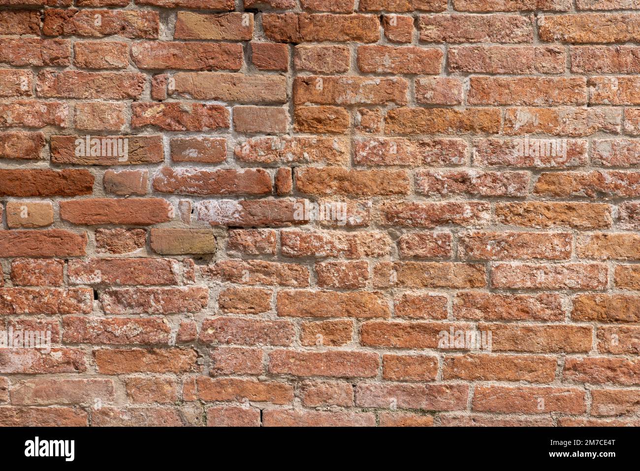 Old red brick clay wall with on a sunny day. Clay brick walls of Italy ...