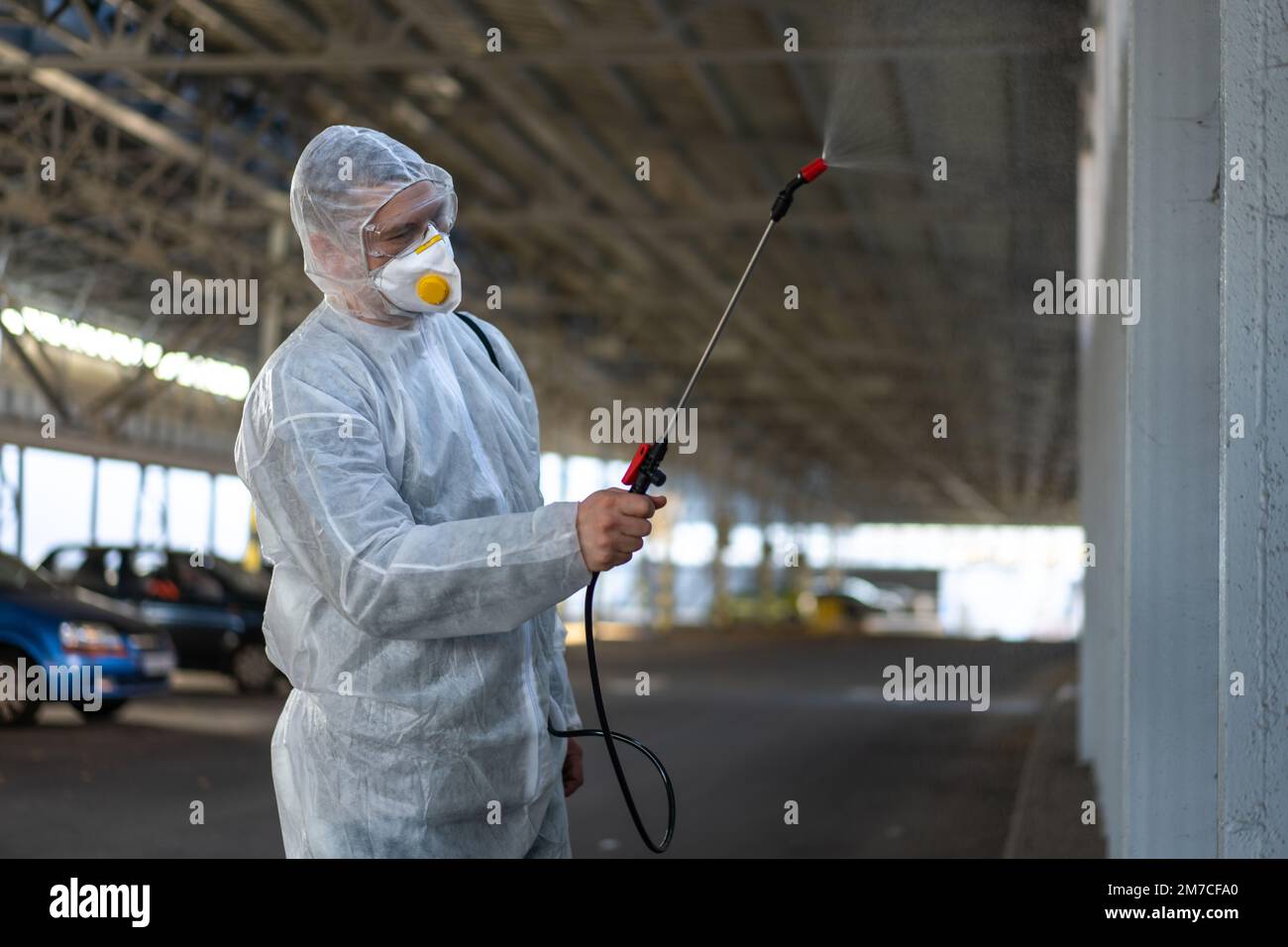 Worker wearing protective suit disinfection gear disinfect surface ...