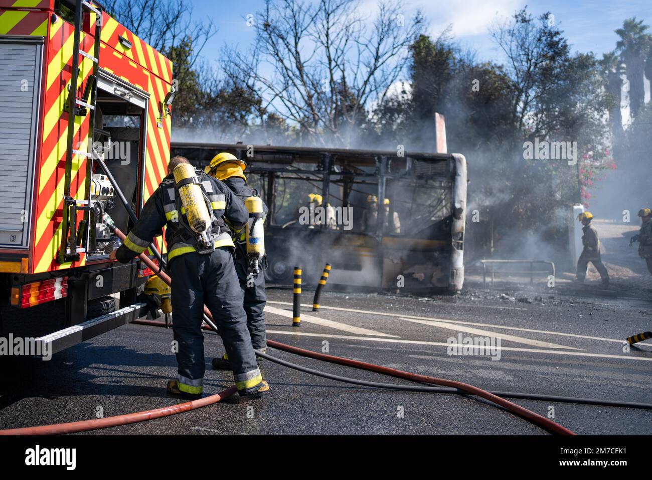 Rescue Team of Firefighters Arrive on the Car Crash fired passenger bus ...