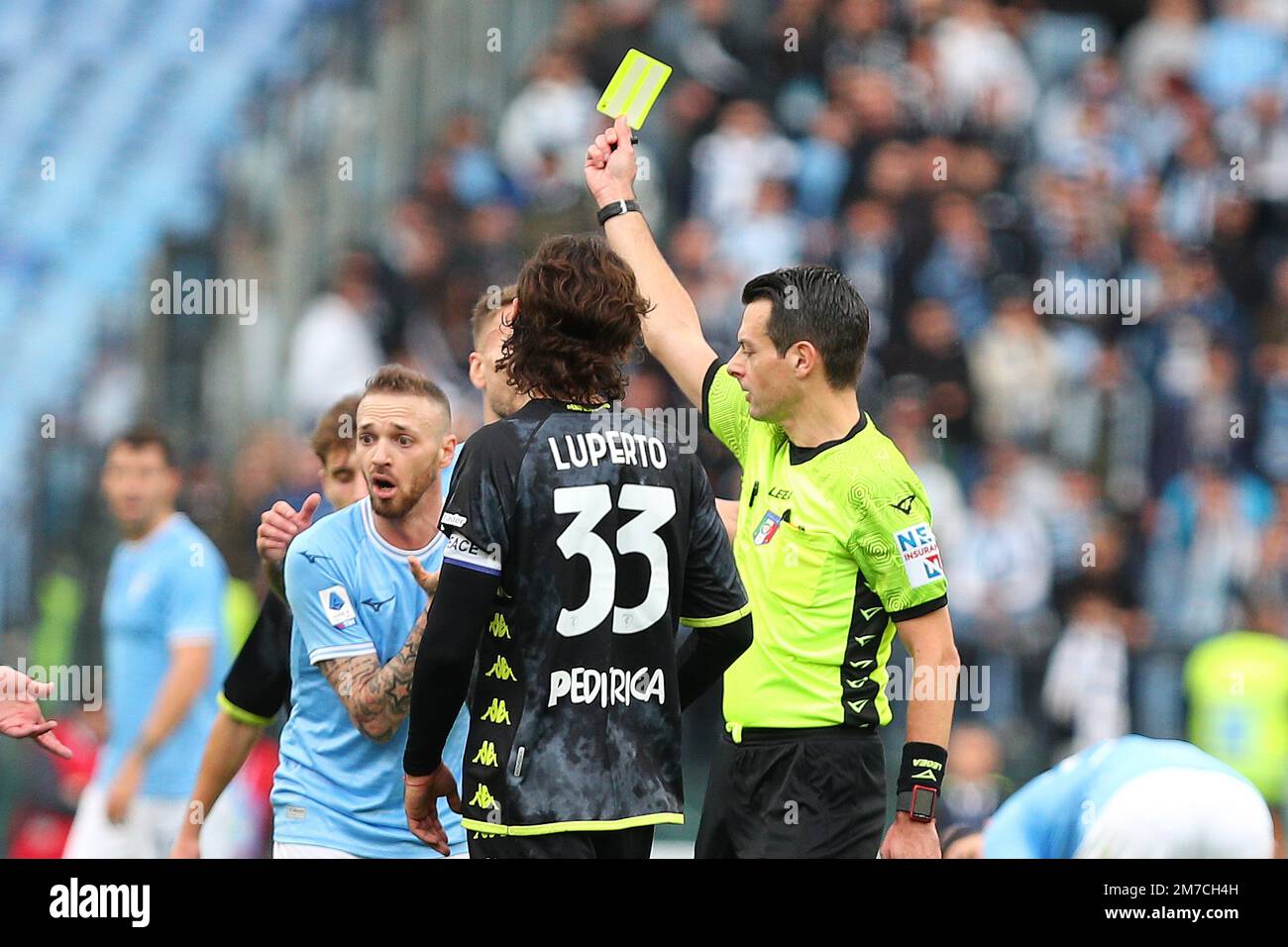 The referee Ivano Pezzuto shows the yellow card to Manuel Lazzari of ...