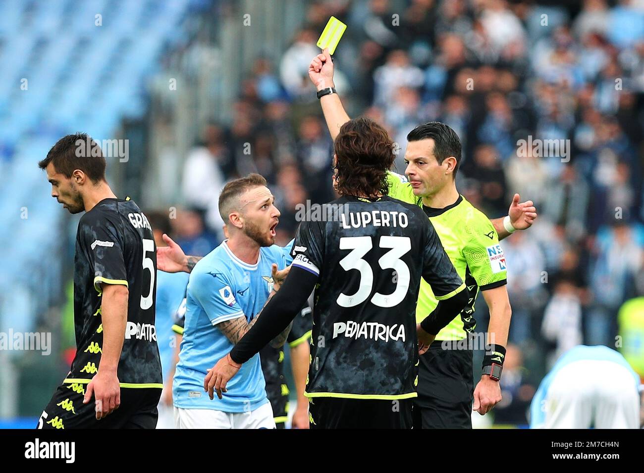 The referee Ivano Pezzuto shows the yellow card to Manuel Lazzari of ...