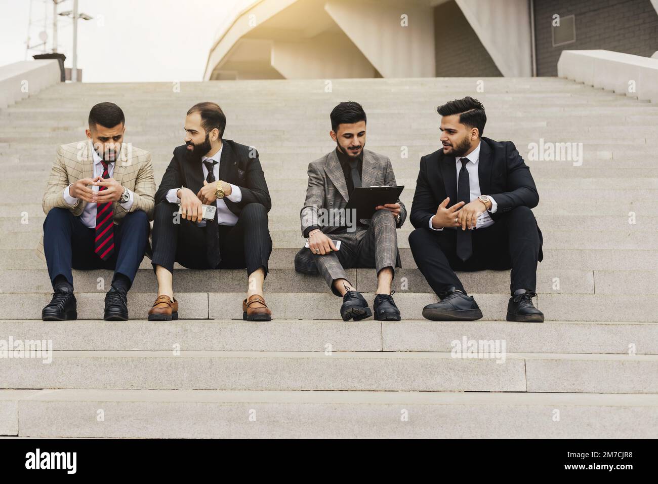 Male executive sitting on steps hi-res stock photography and images - Alamy