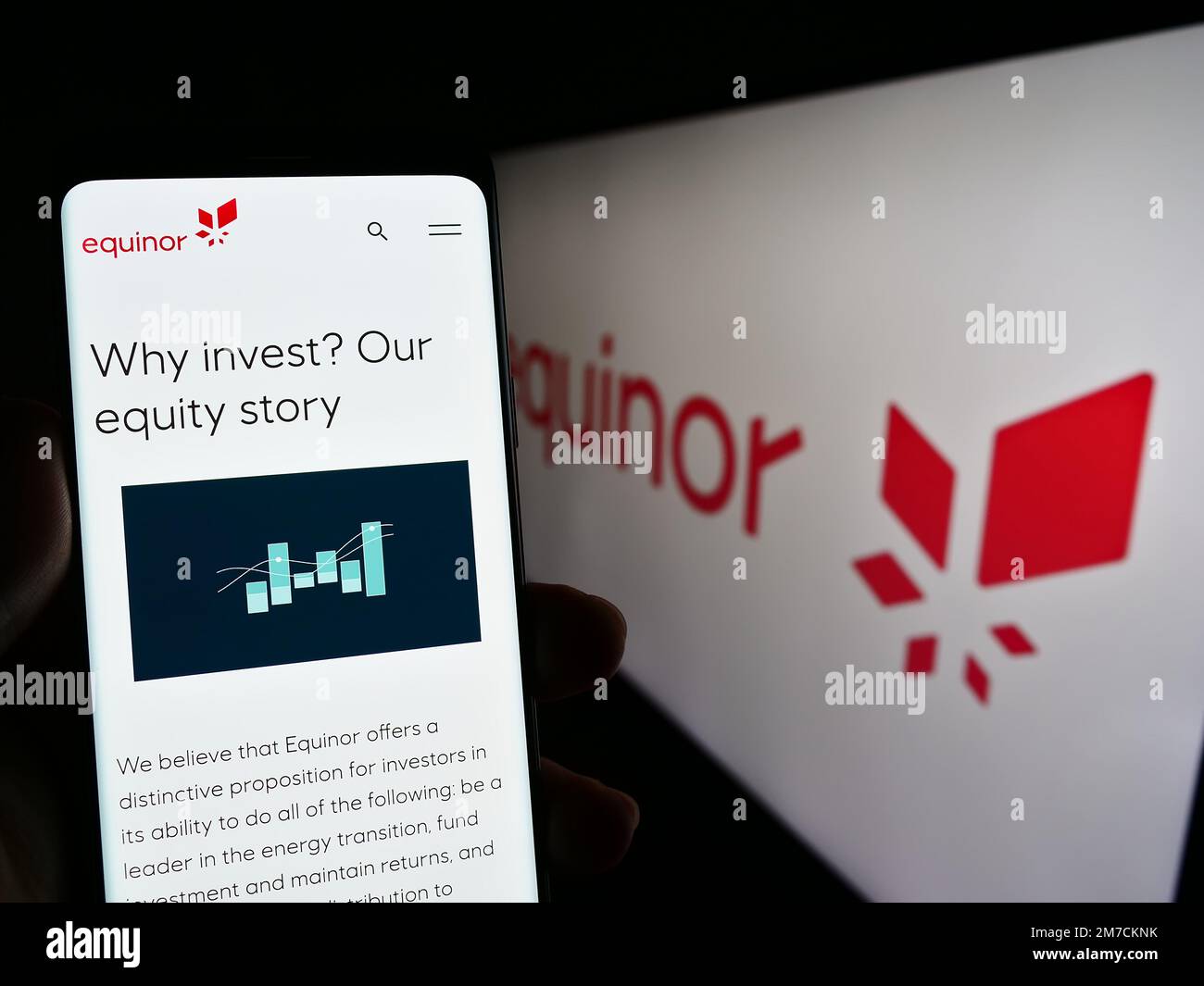 Person holding cellphone with webpage of Norwegian energy company ...